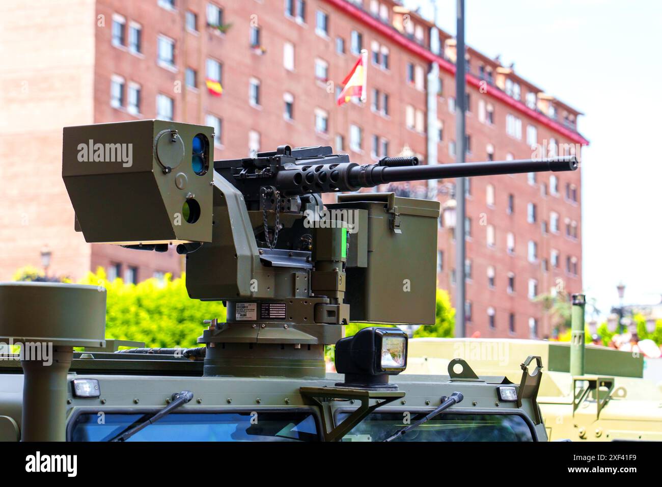 A heavy machine gun on top of an armored off-road vehicle of the ...