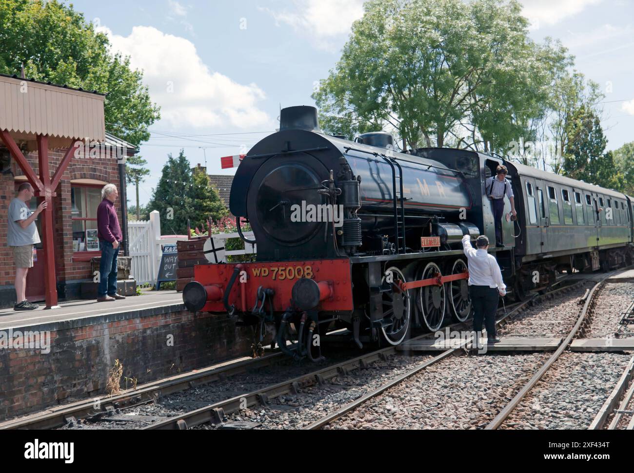 A Signal man exchanging a token with the fireman on Locomotive No ...