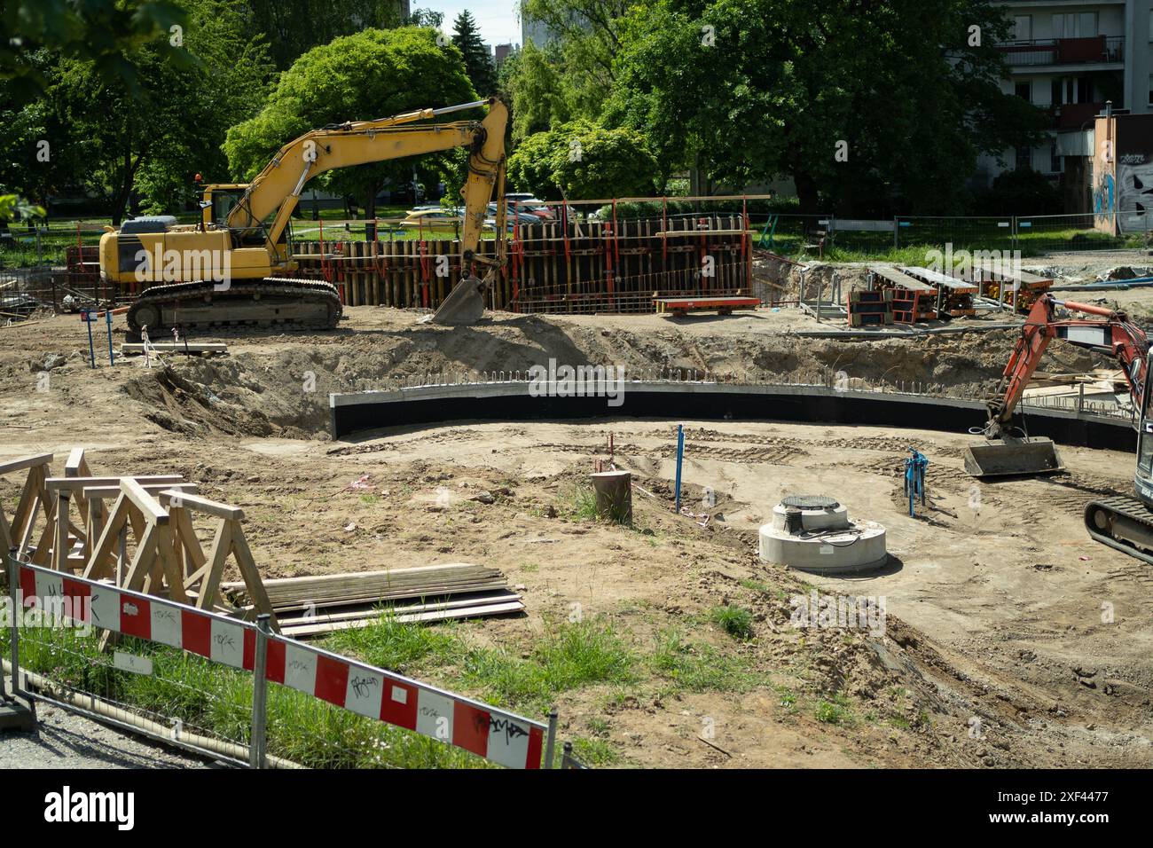 Street under repair with dug holes and construction equipment Stock ...