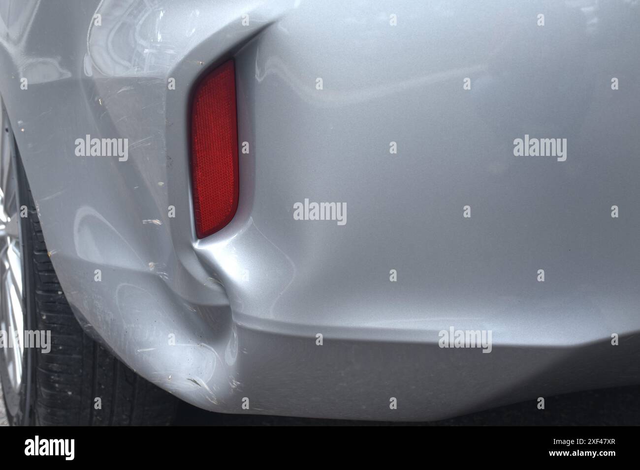 pound and scratch from accident on bumper of silver color car ...