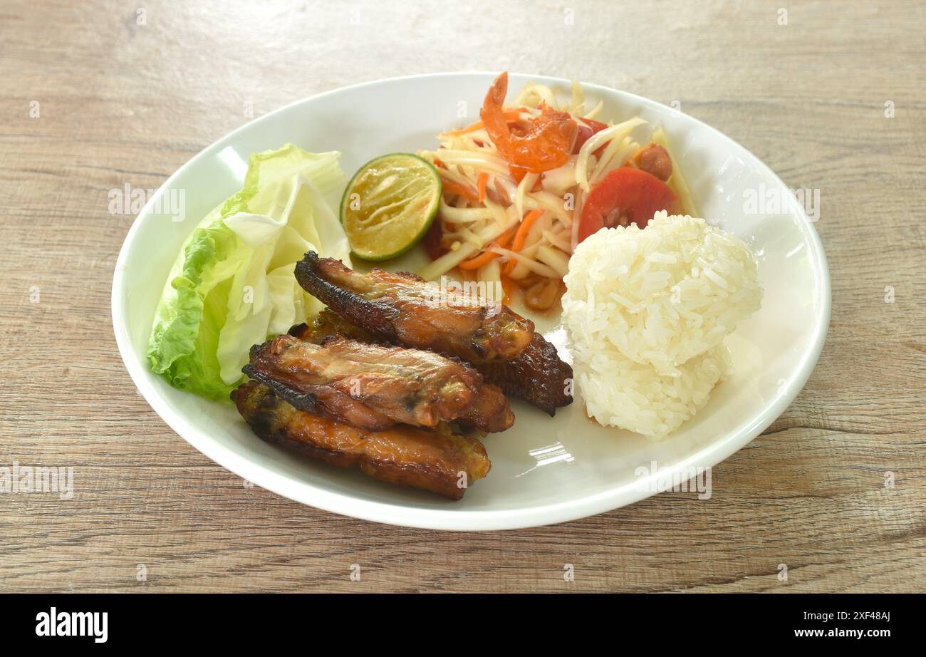 Som tum Thai spicy green papaya salad with roasted chicken wing eat ...