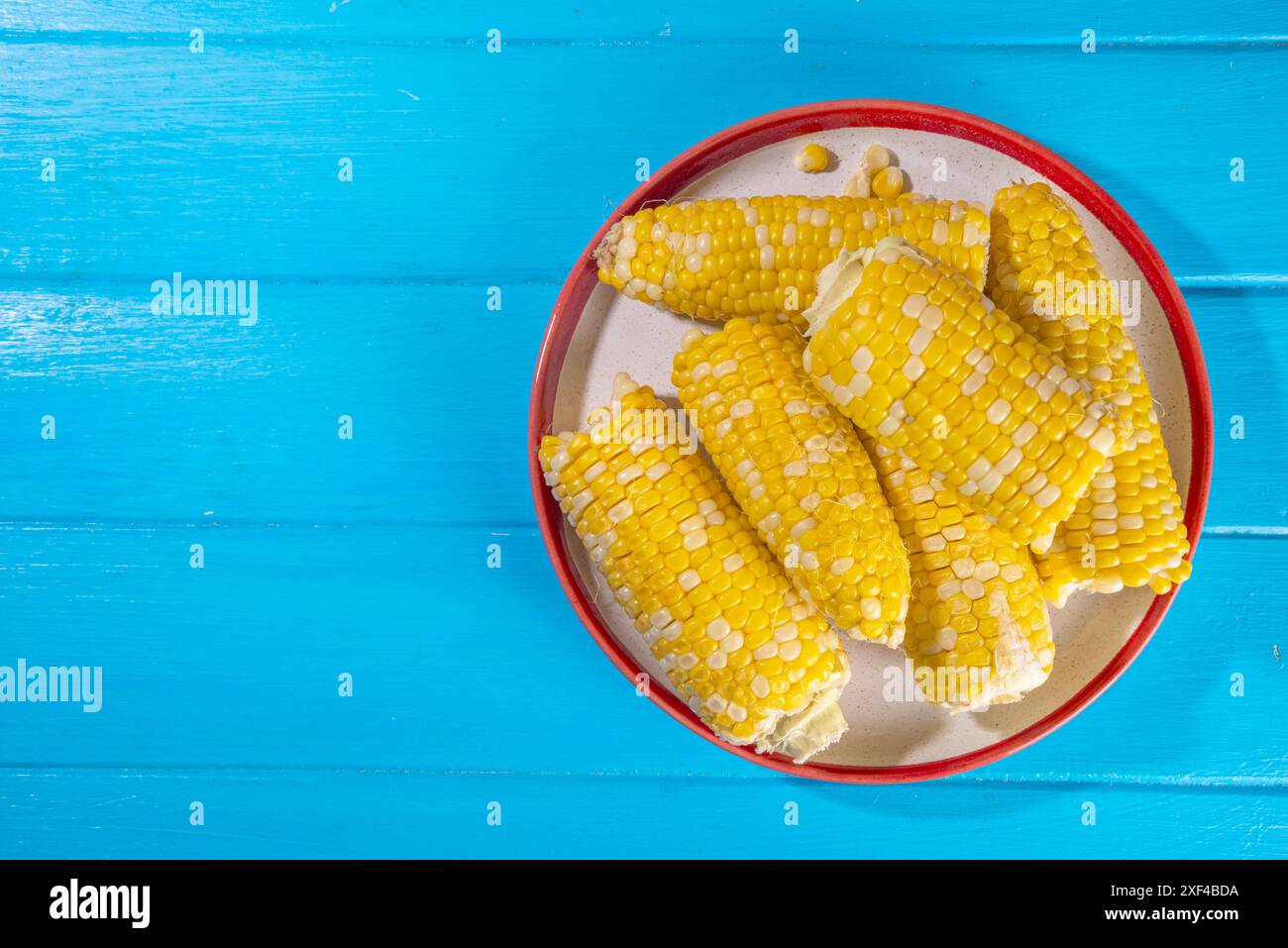 Sweet boiled corn cobs portions on plate, copy space Stock Photo - Alamy