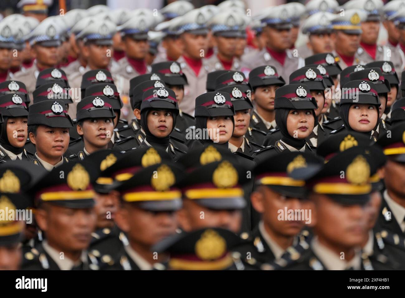 Members of Indonesian police march during a ceremony commemorating the ...