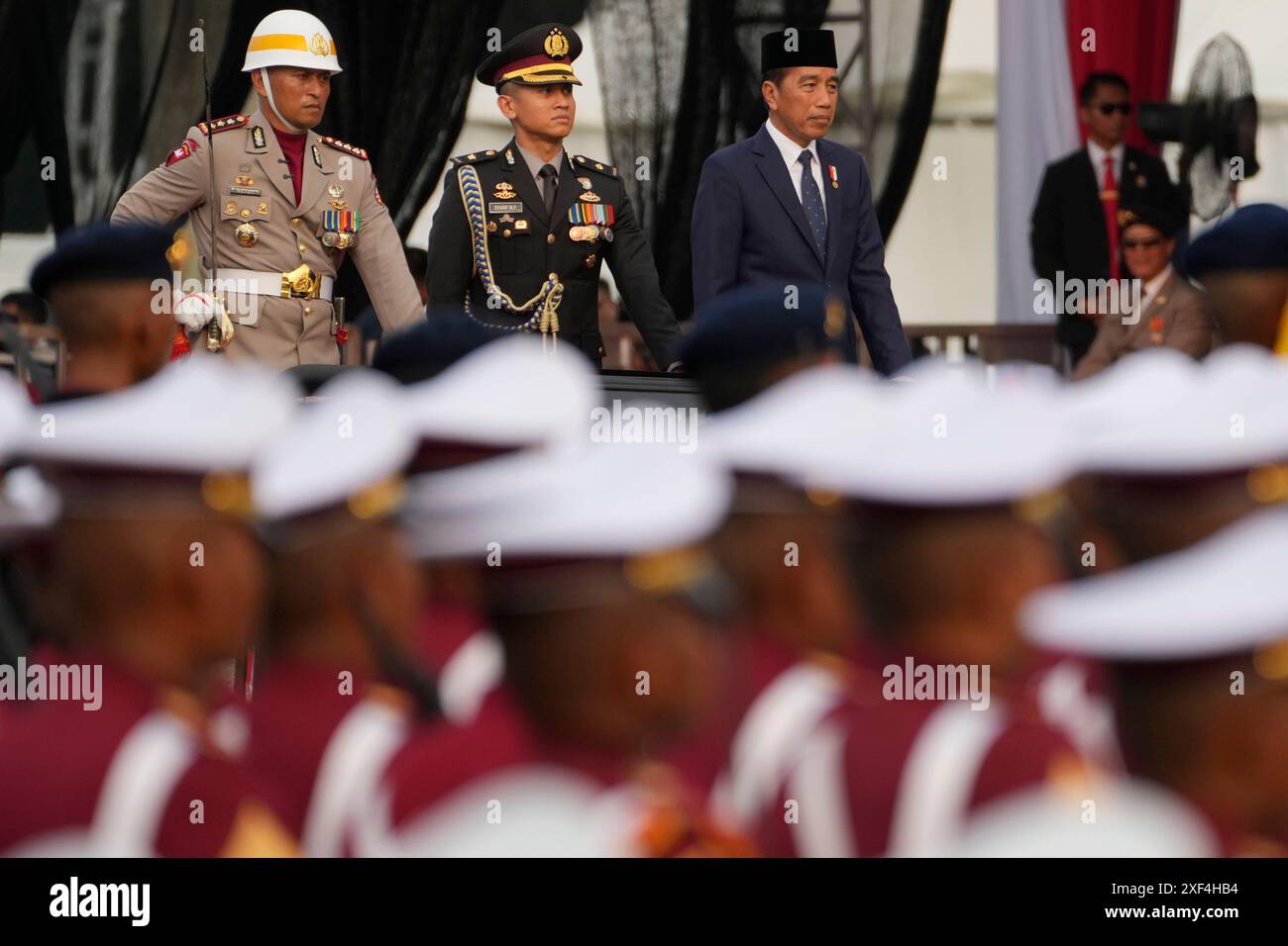 Indonesian President Joko Widodo, right, attends a ceremony ...