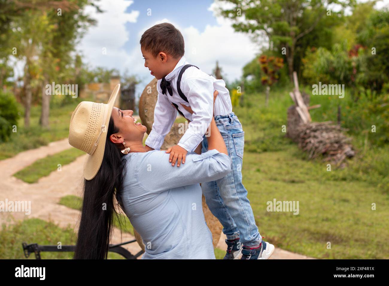 lifestyle: mother and child with down syndrome outdoors playing and ...