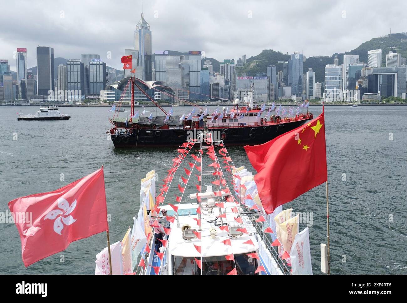 Hong Kong, China. 1st July, 2024. Fishing vessels take part in a cruise ...