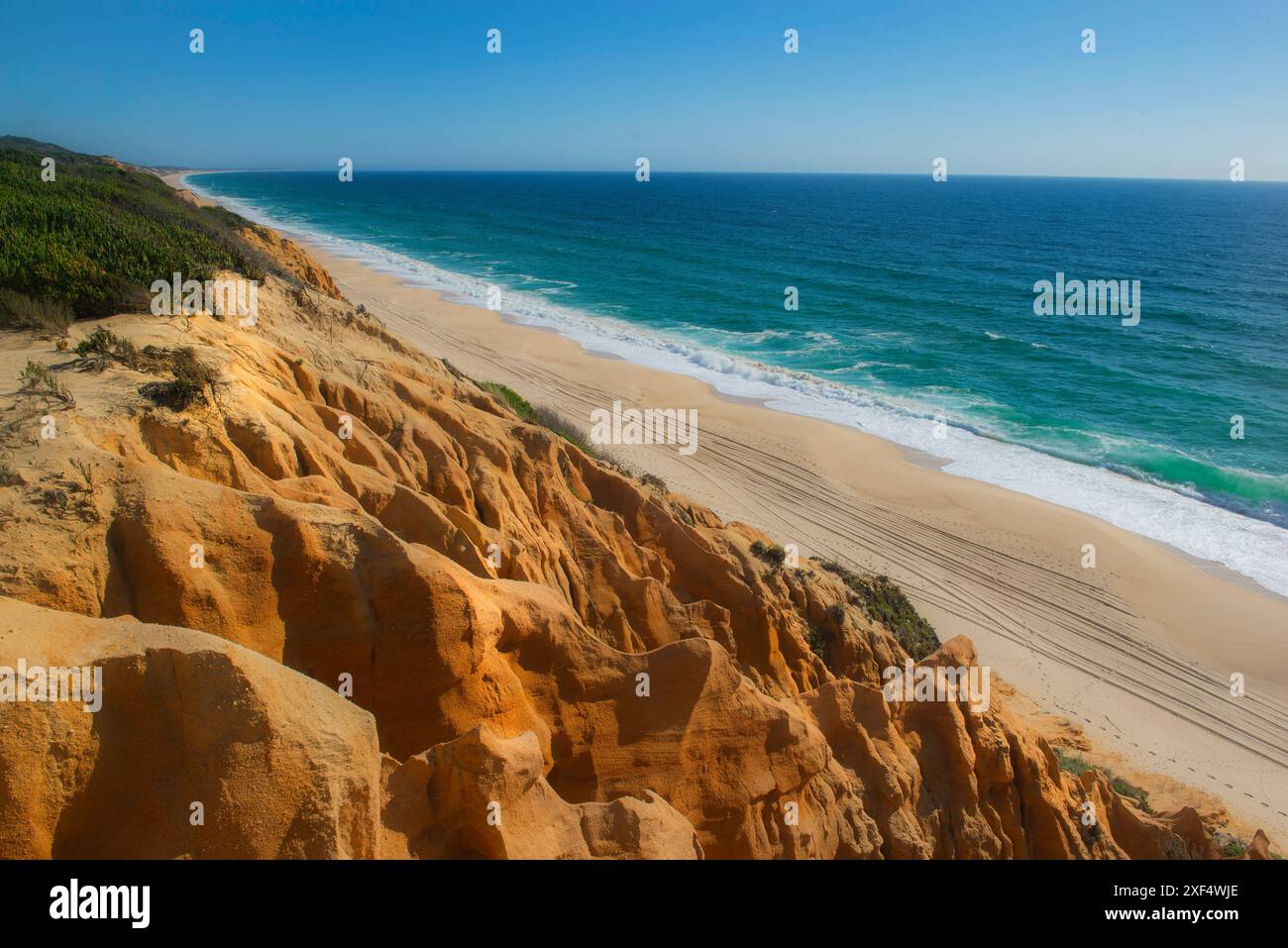 beautiful beach in the Atlantic Ocean bordered by hard sand cliffs ...