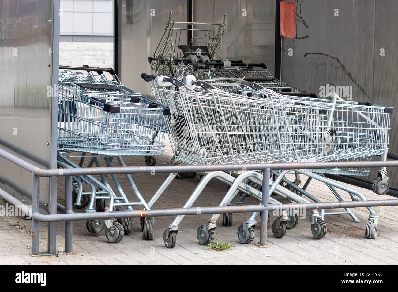 A group of shopping carts is piled up in a stack, made of various ...