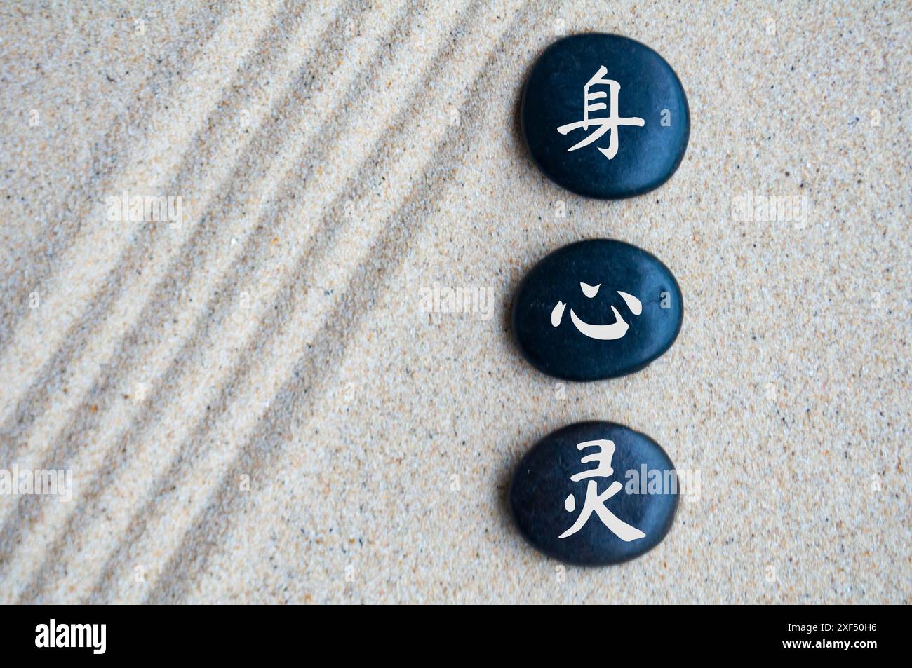 Top view of body, mind and spirit in Chinese character on zen stones ...