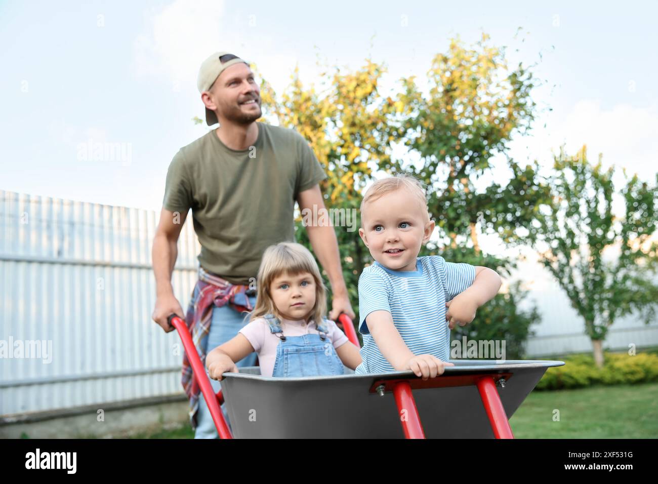 Happy male farmer wheelbarrow hi-res stock photography and images - Alamy