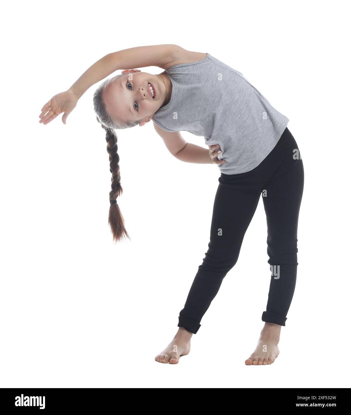 Cute little girl stretching on white background Stock Photo - Alamy