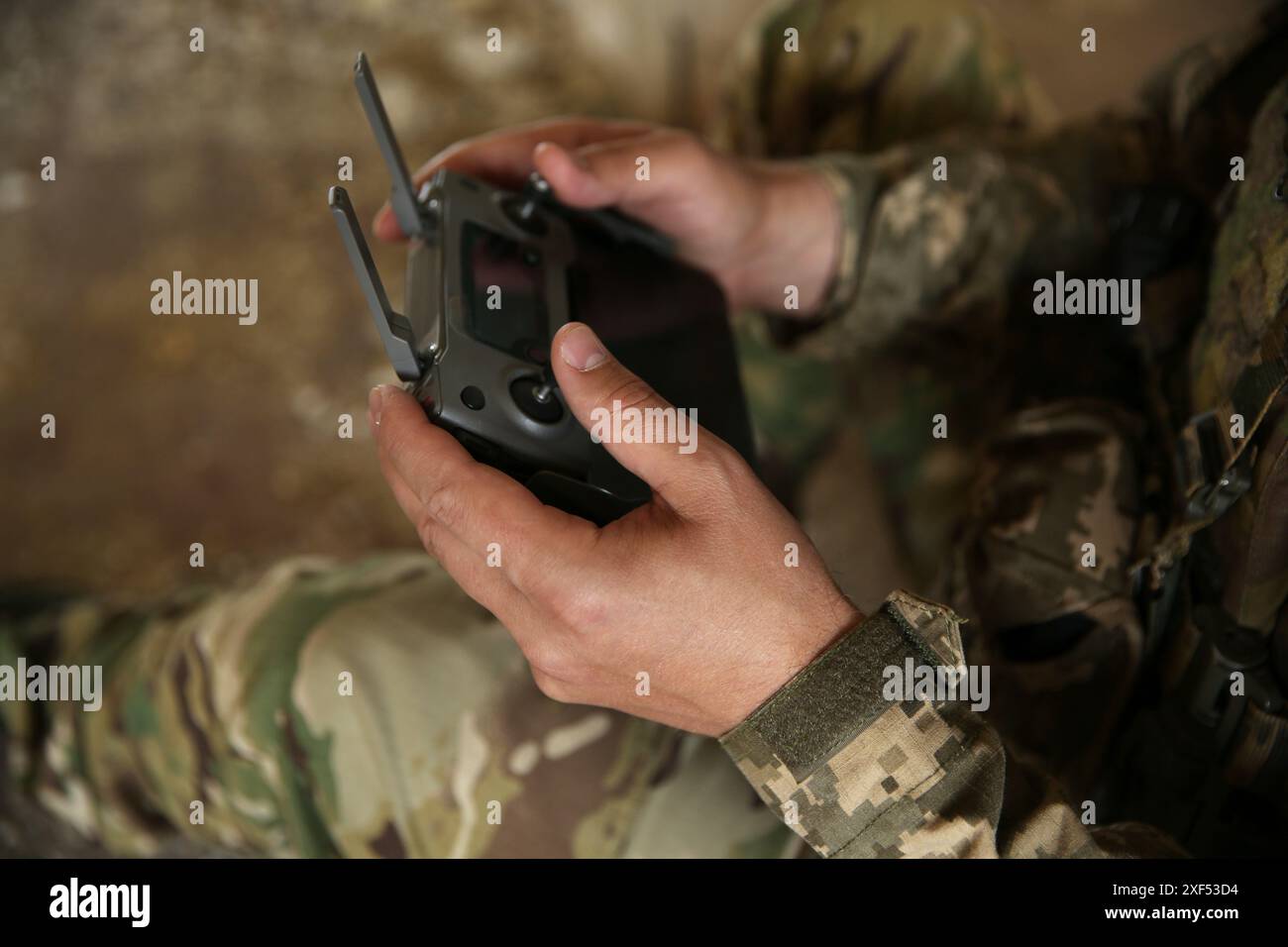 Military mission. Soldier in uniform with drone controller inside ...