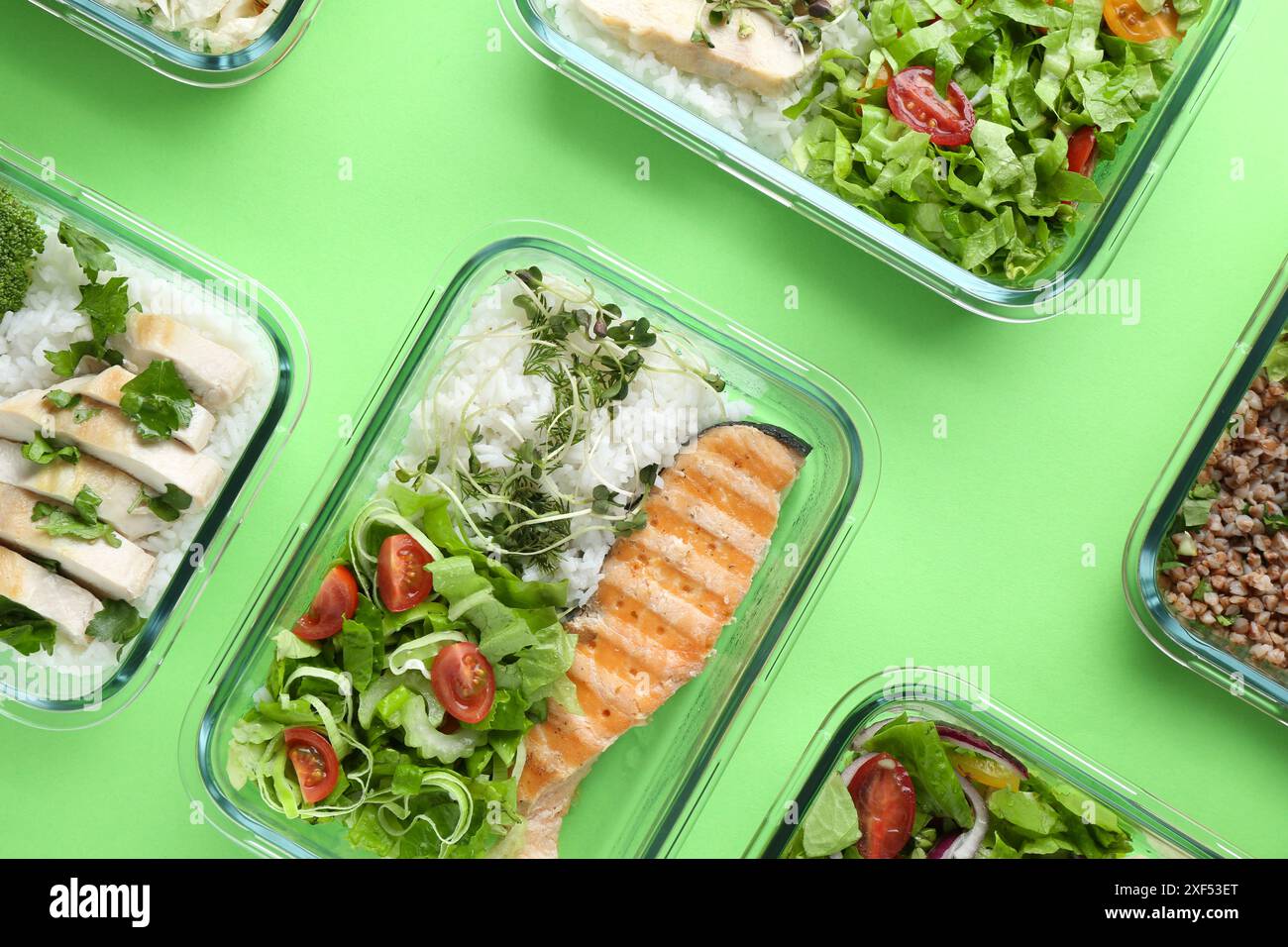 Healthy food. Different meals in glass containers on green background ...