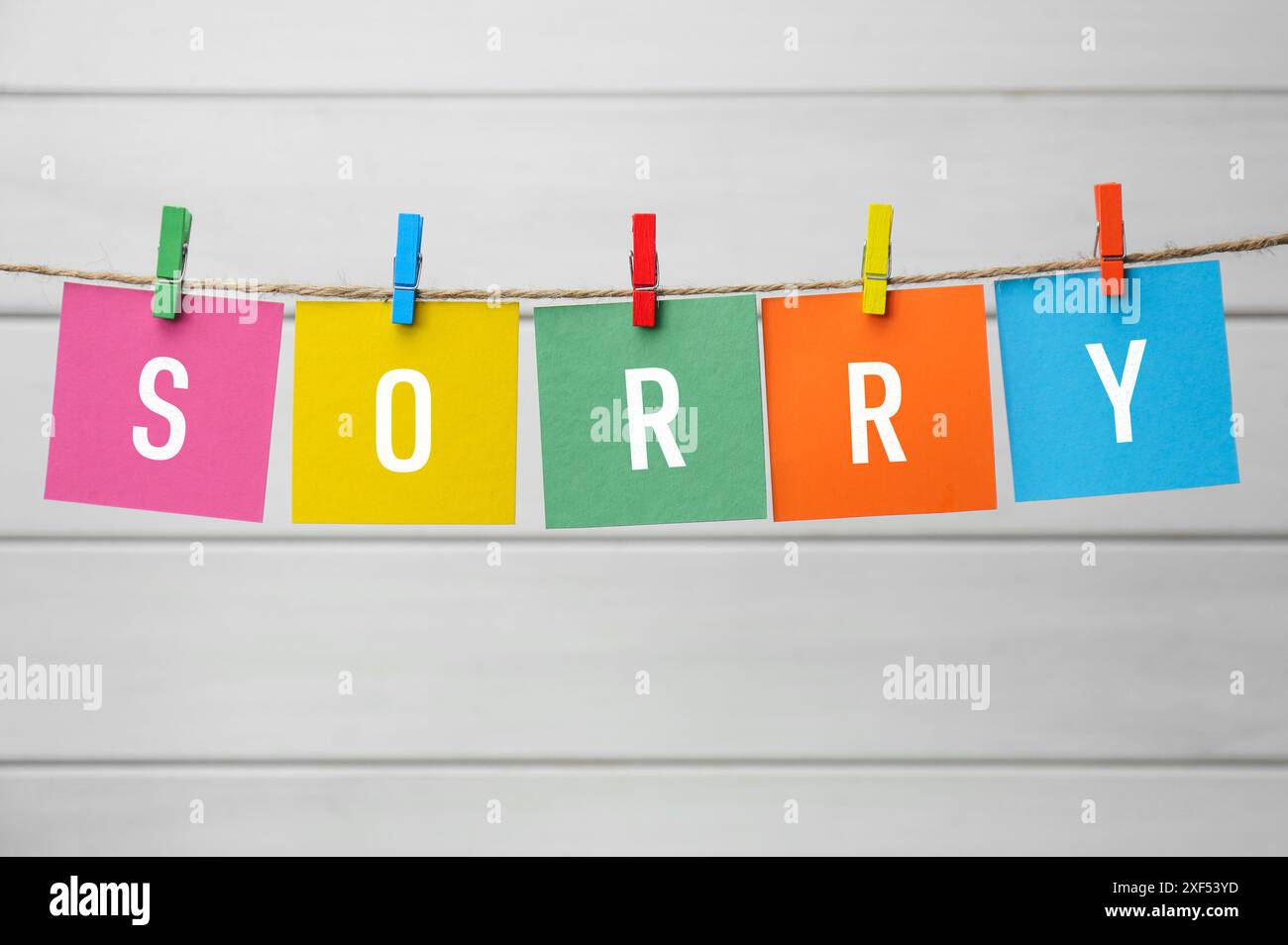 Word Sorry made of paper notes with letters hanging on rope against ...
