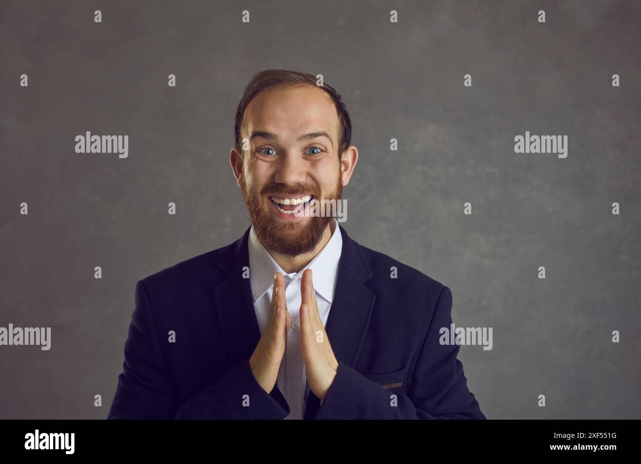 Studio headshot portrait of young happy handsome businessman clapping ...