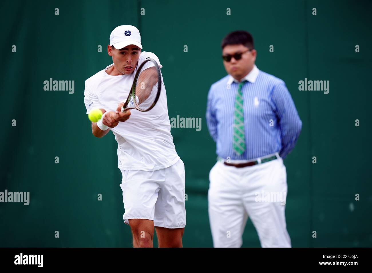 Charles Broom in action against Stan Wawrinka (not pictured) on day one ...