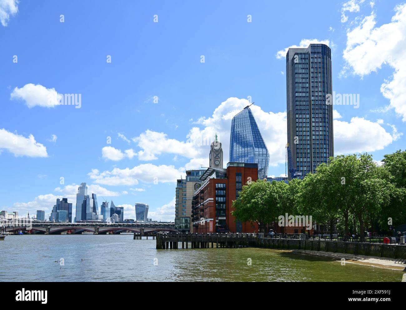 Skyscrapers and jetty on the south bank of the River Thames and city ...