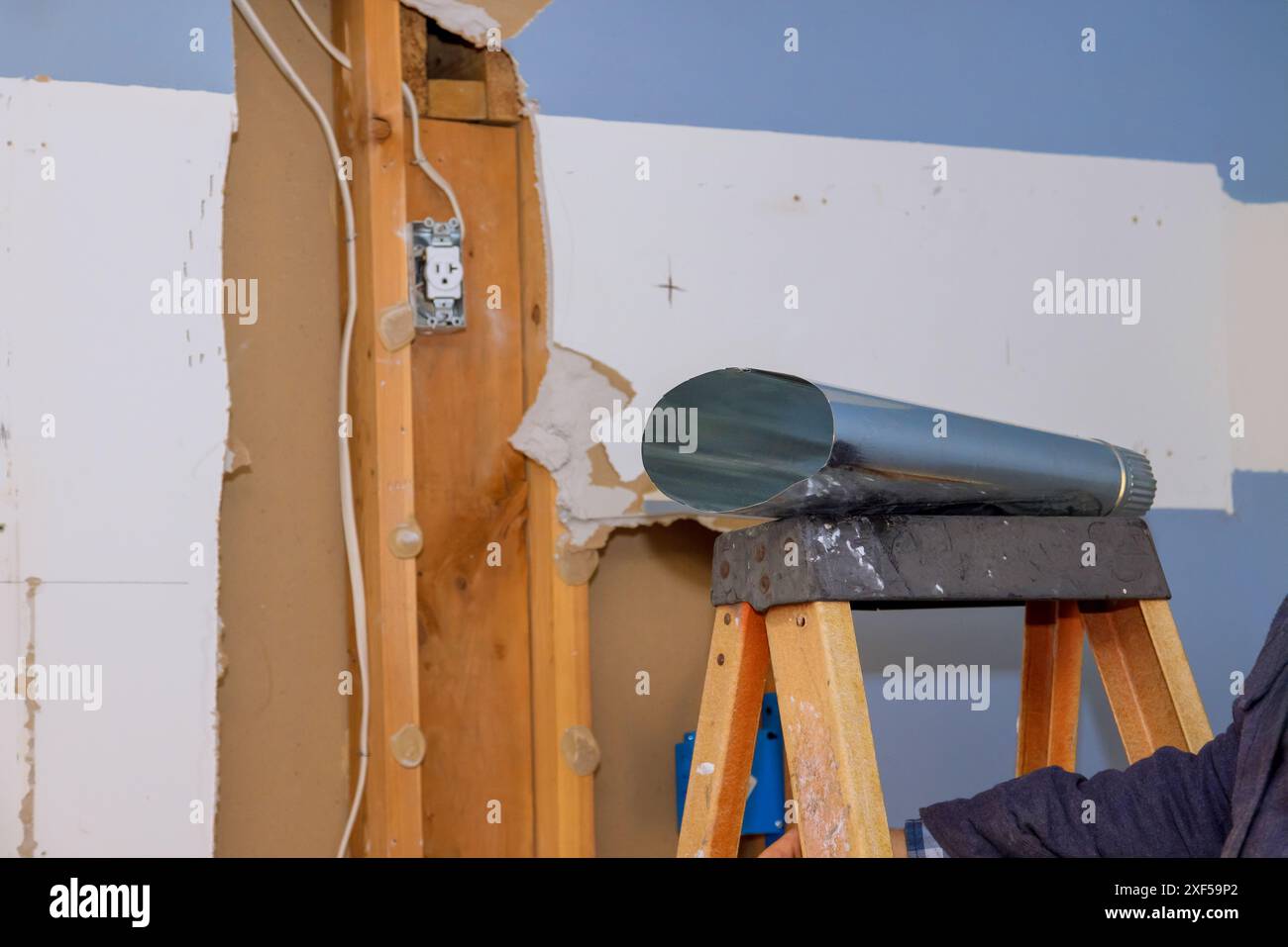 Ventilation HVAC system is installed in room of house while it is being ...