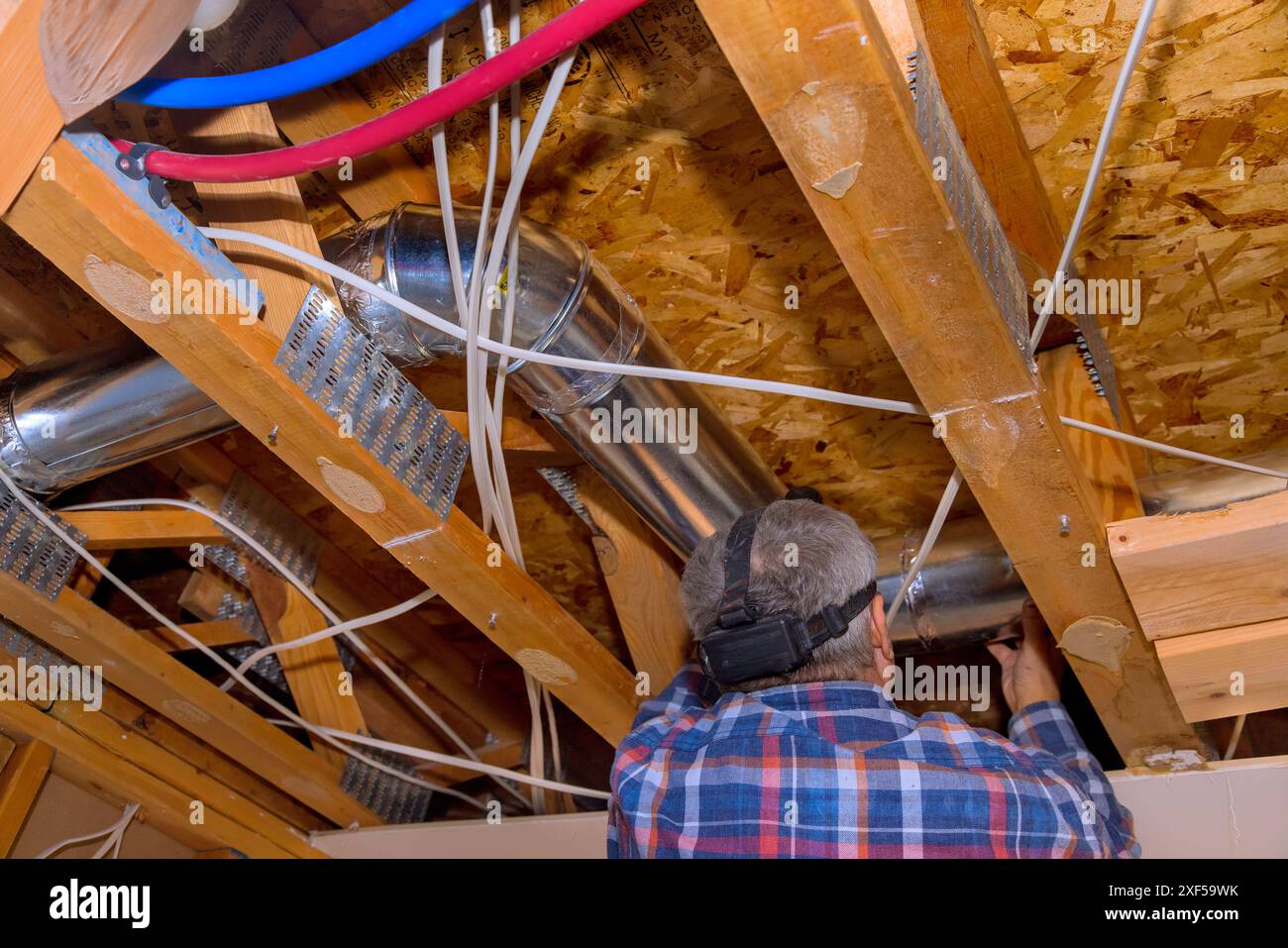 During construction of house, ventilation HVAC system is installed in ...