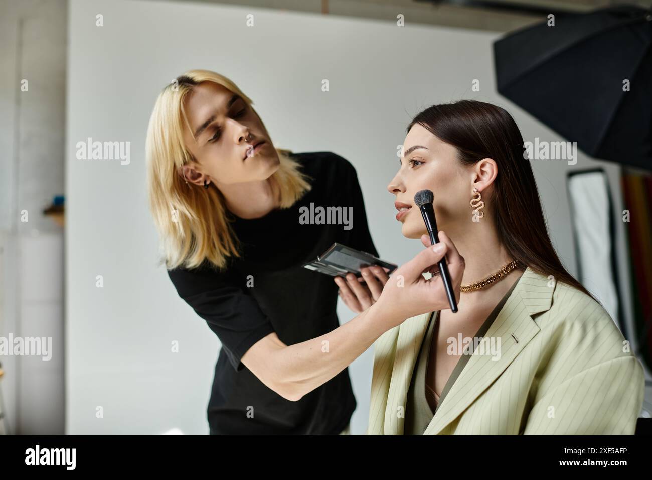 A woman receiving professional makeup application from a skilled artist ...
