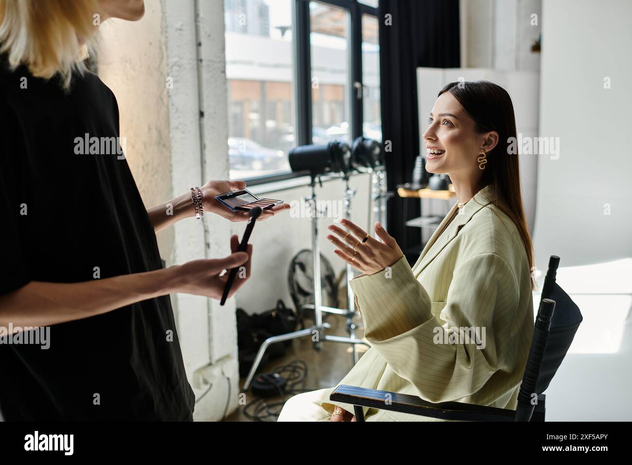Talented professional stylist applying makeup on womans face Stock ...