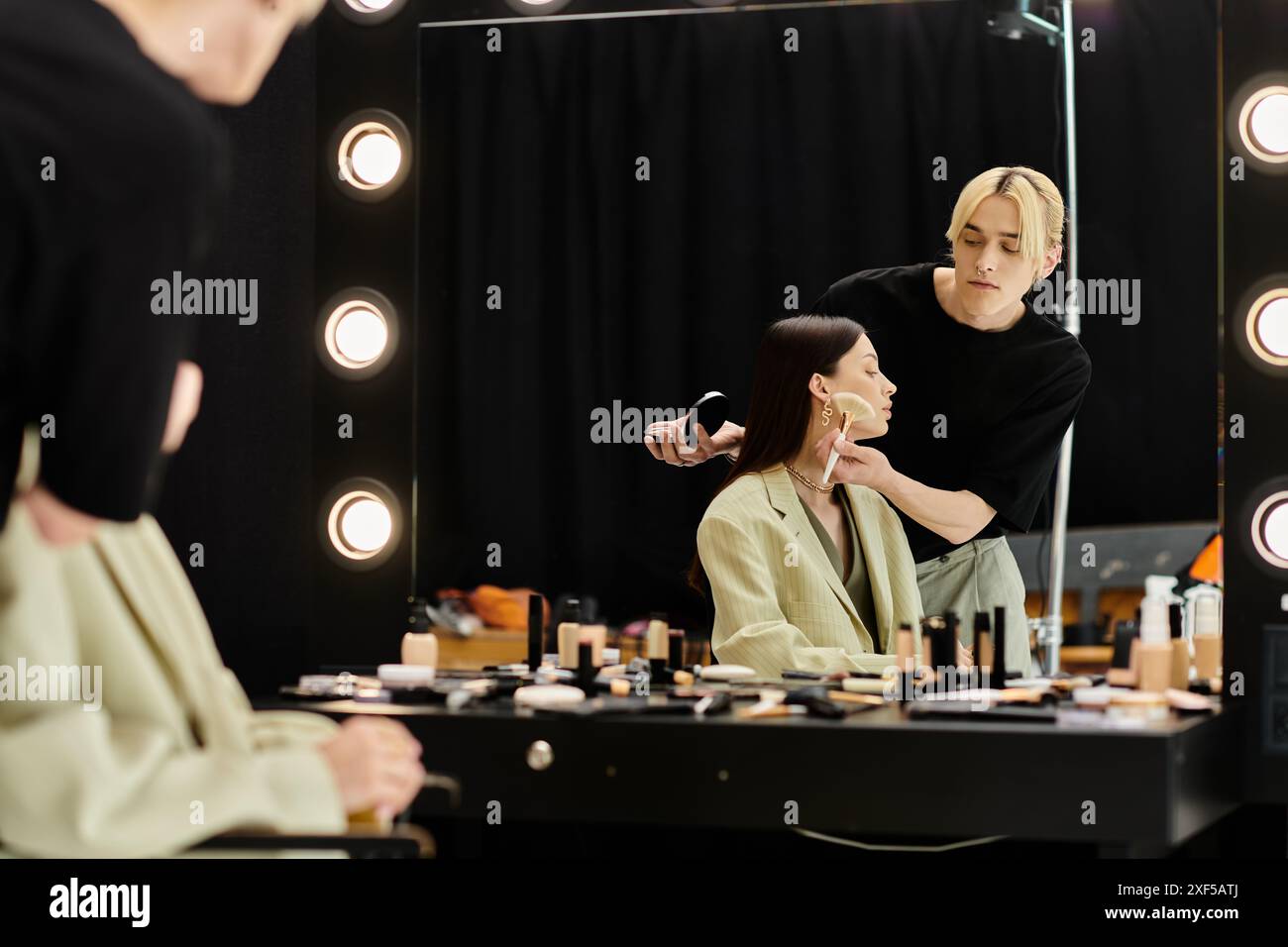Beautiful woman enjoying makeup session with stylist Stock Photo - Alamy