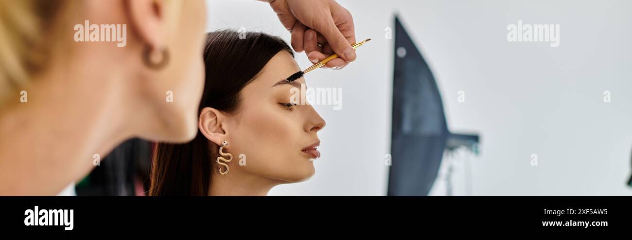 Elegant woman enjoying makeup session with stylist Stock Photo - Alamy