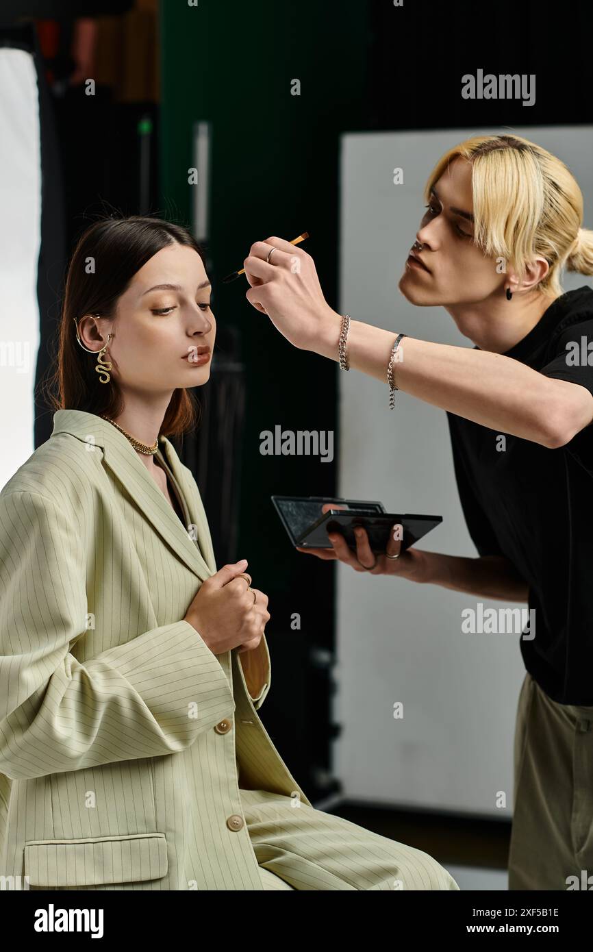 A makeup artist applies makeup to a female clients face Stock Photo - Alamy