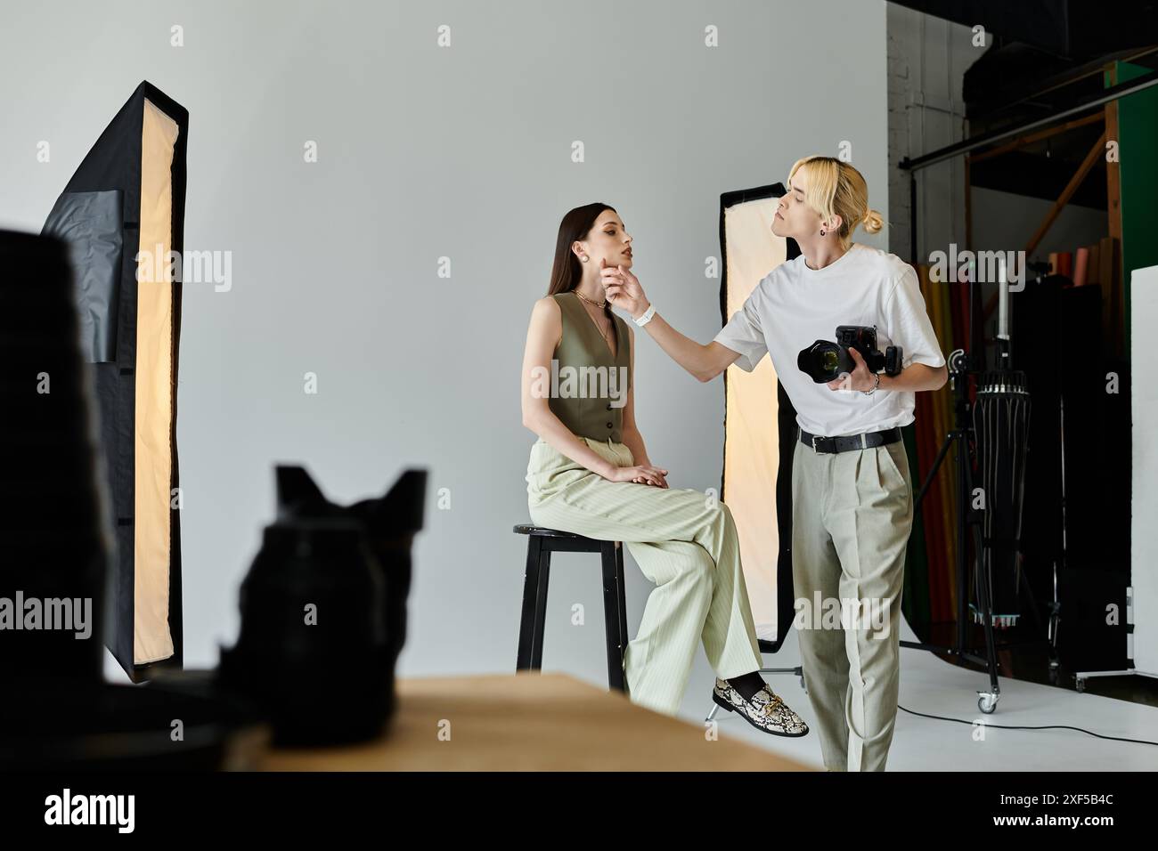 A man photographing a female model in a creative setting Stock Photo ...