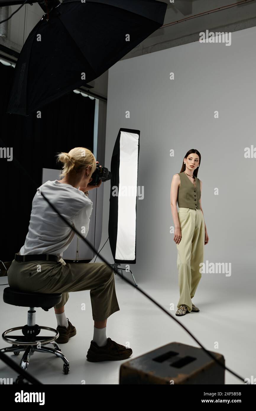 Woman posing, facing camera during a photoshoot with a photographer ...