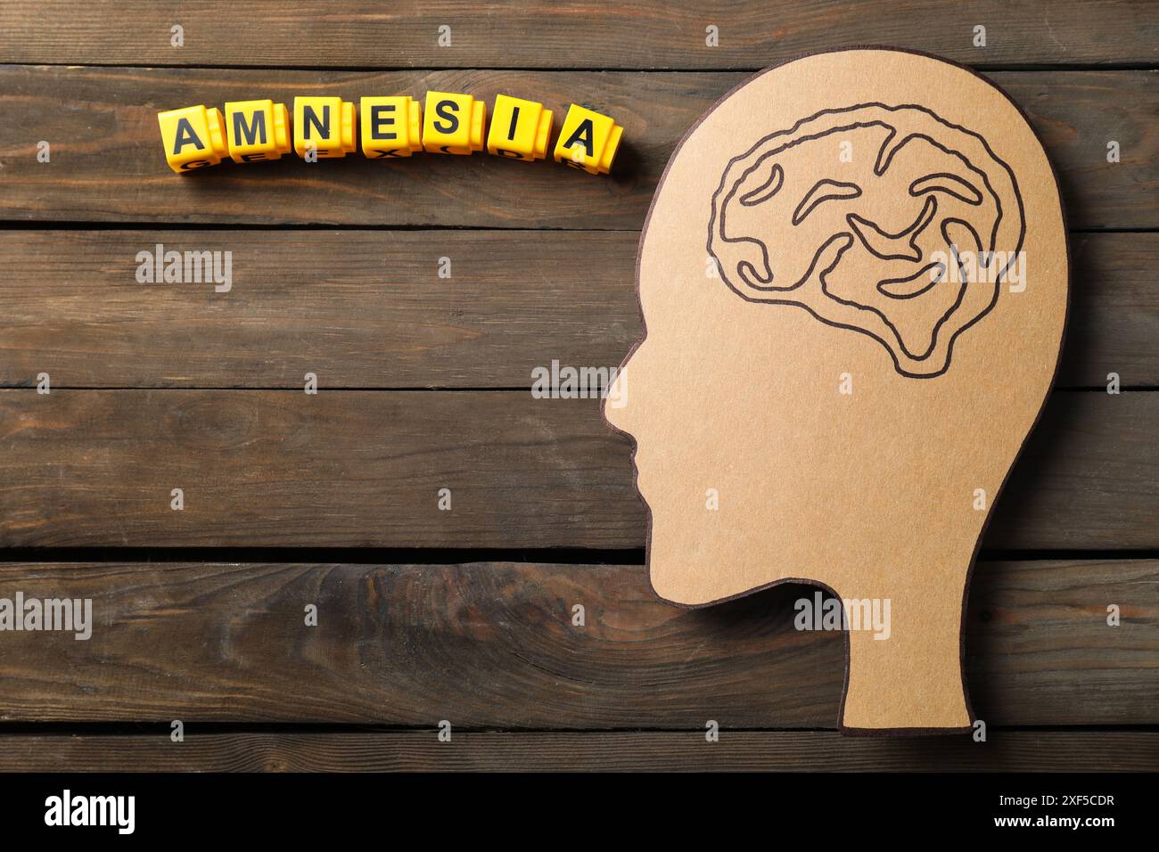 Yellow cubes with word Amnesia and human head cutout with drawing of ...
