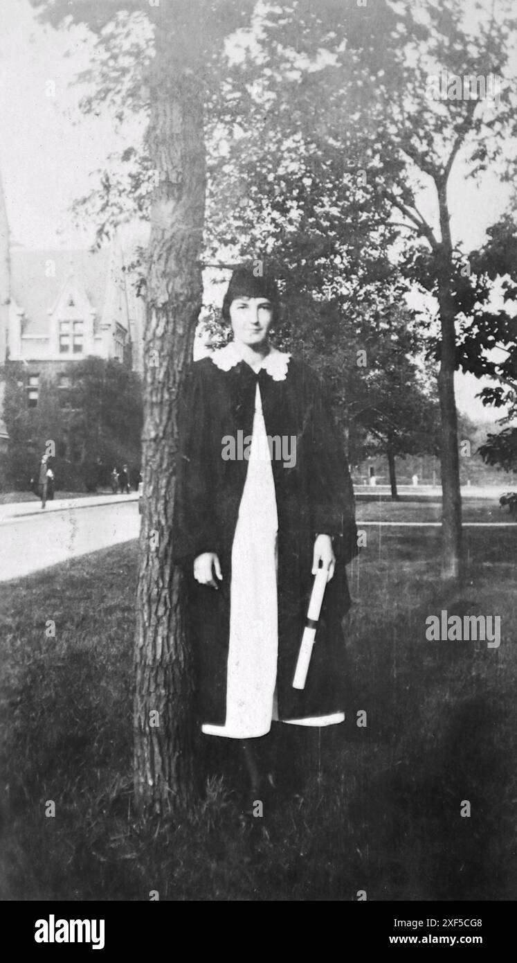 Fashion: A lady beside a tree, wearing a graduation cap and cloak. From ...