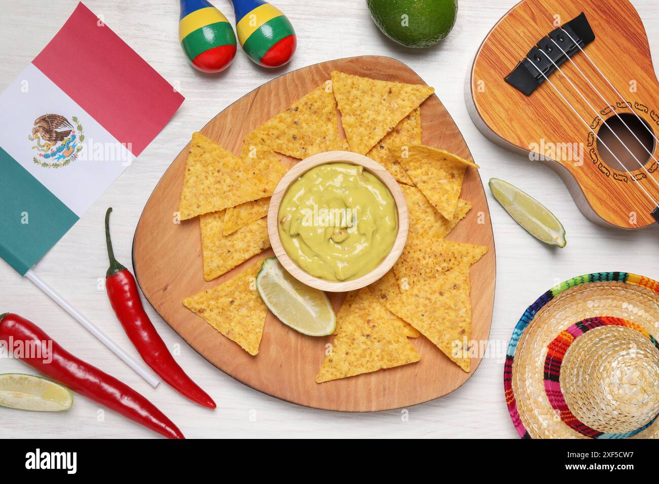 Delicious guacamole with nachos chips, Mexican flag, sombrero hat ...