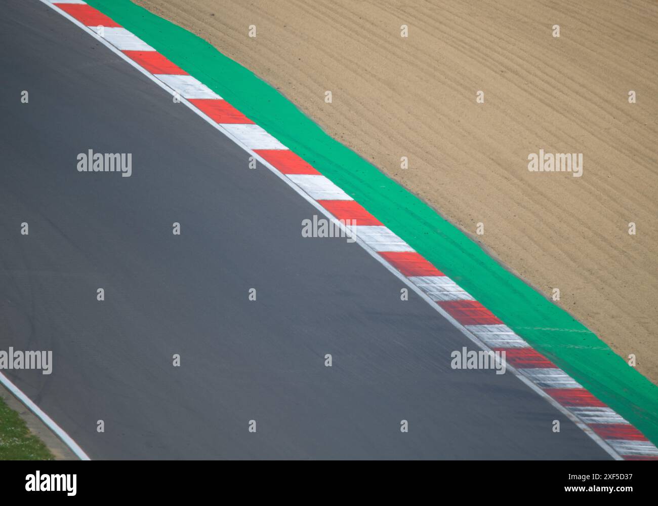 A section of a race track, race circuit with deep grey, gray tarmac ...