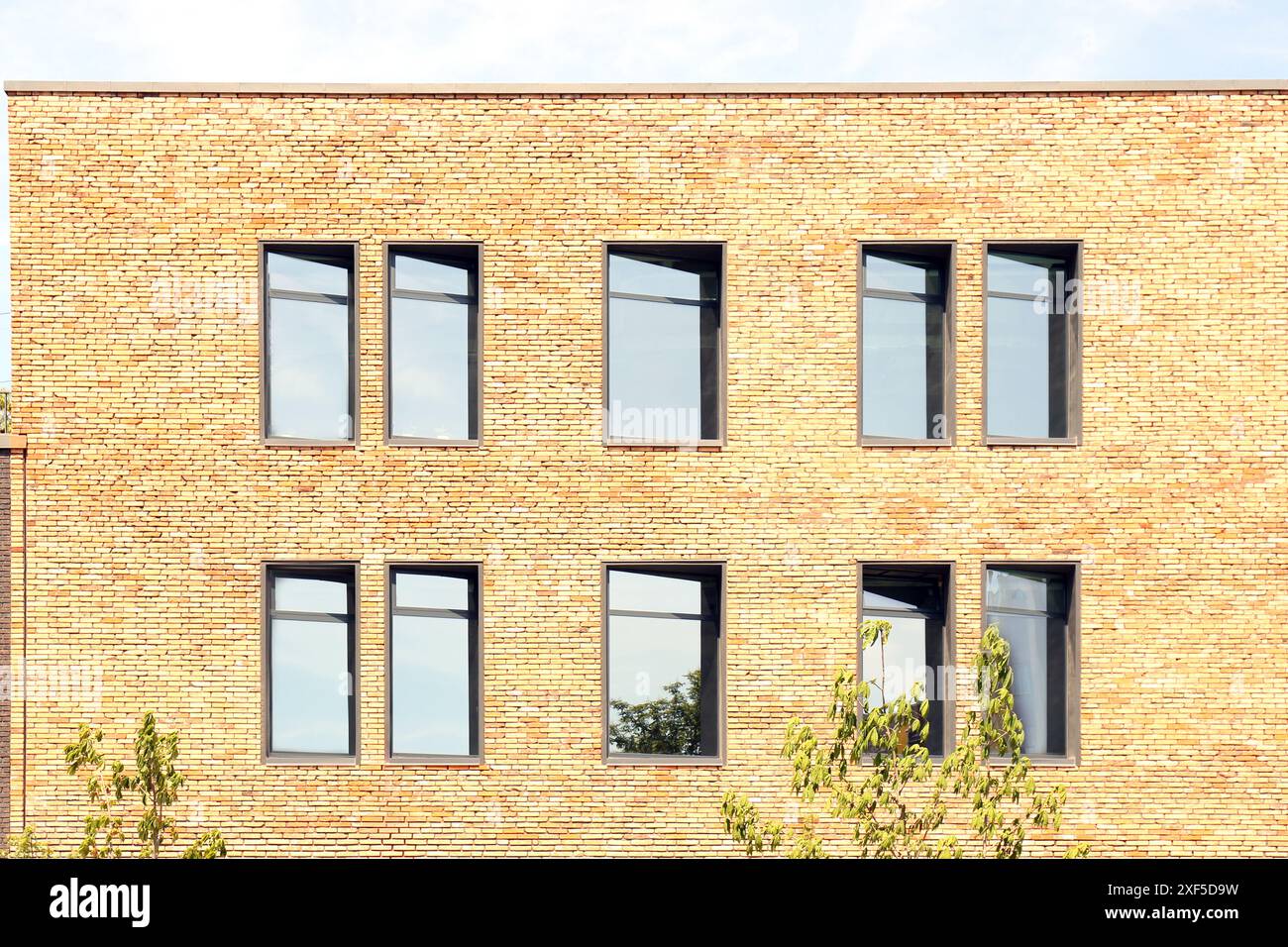 Exterior of brick building with glass windows Stock Photo - Alamy