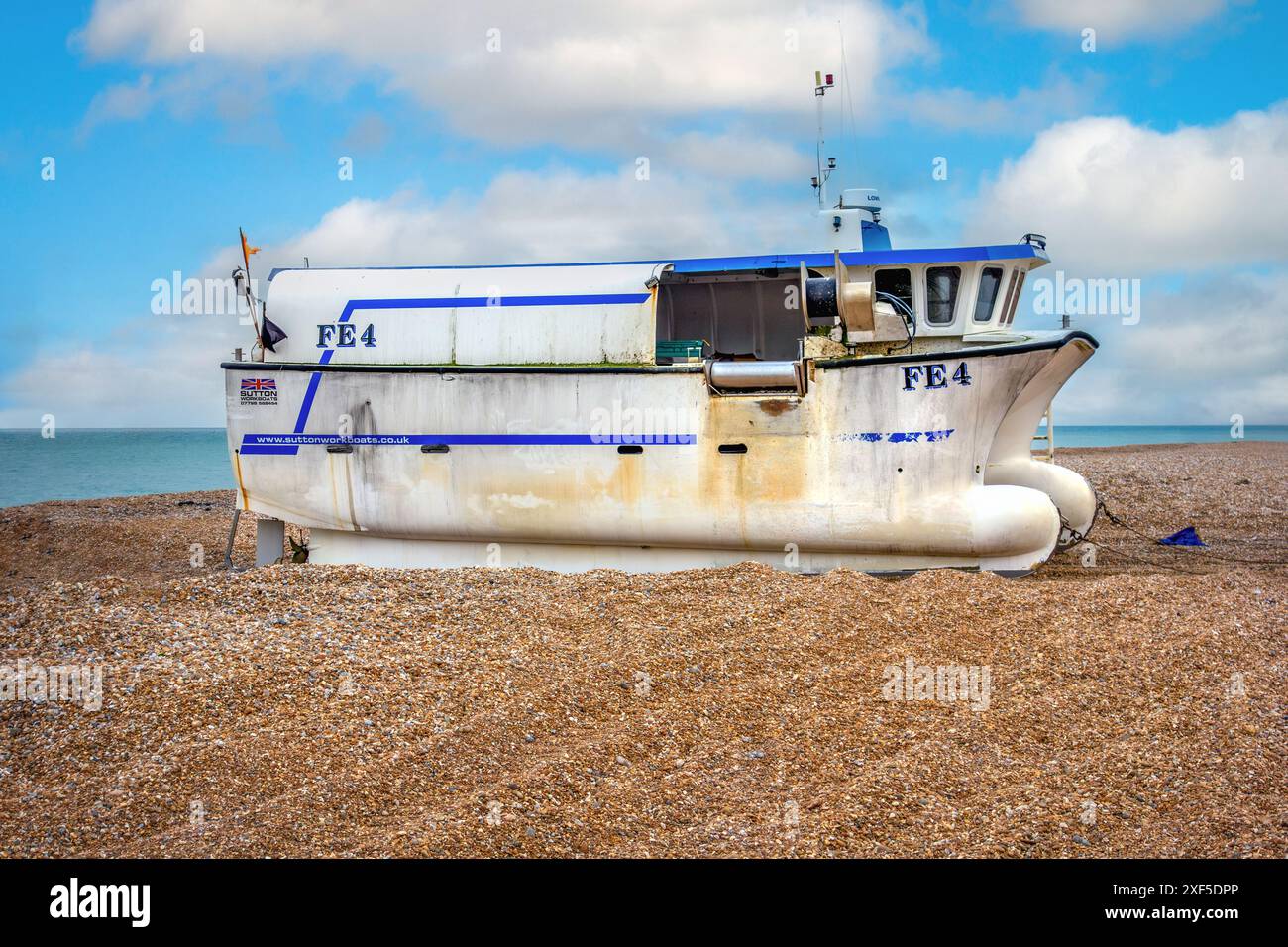 A side view of a white and blue Catamaran fishing boat, named 'FE4 ...