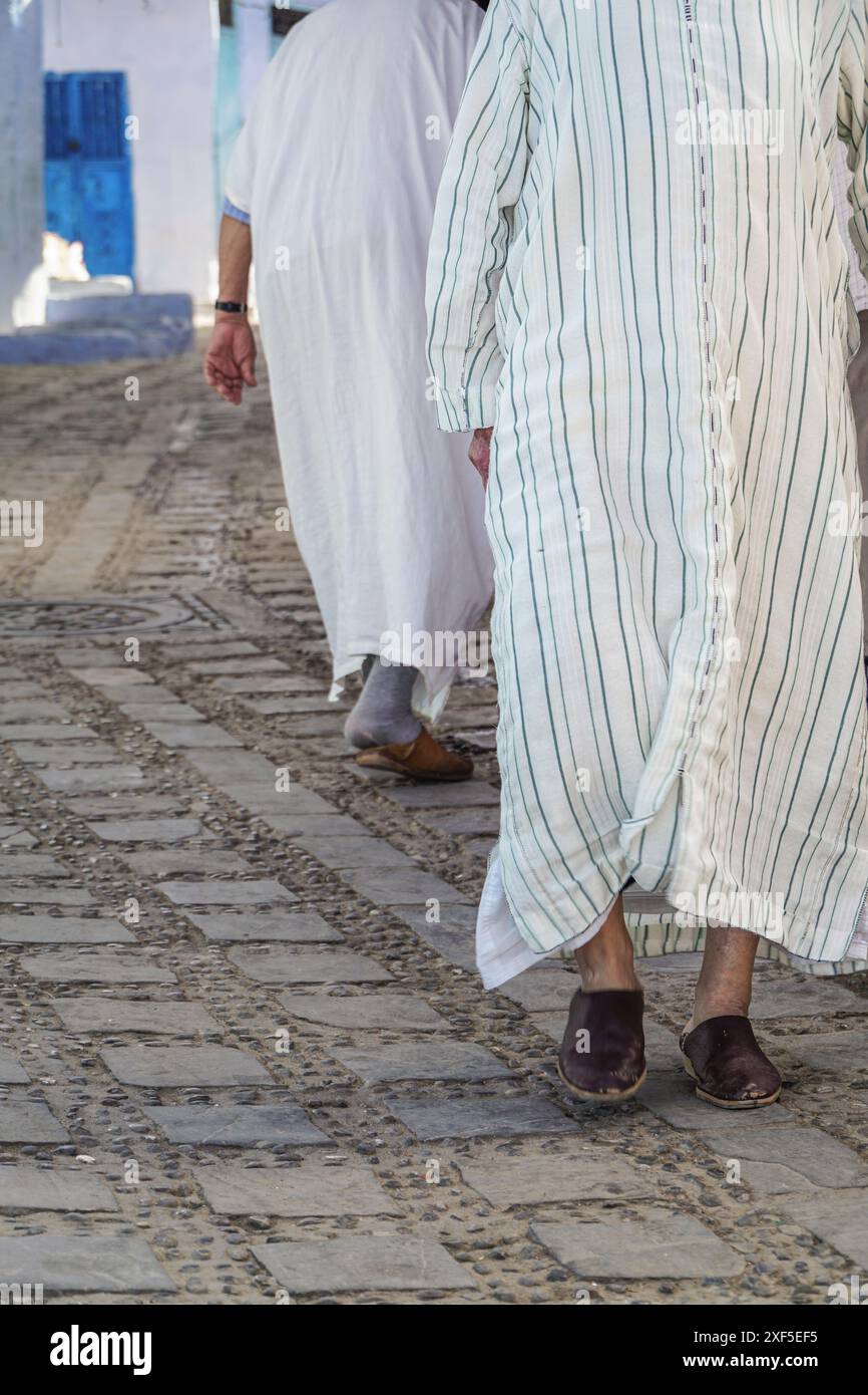 unrecognisable arabic men walking in their traditional clothes thobe ...