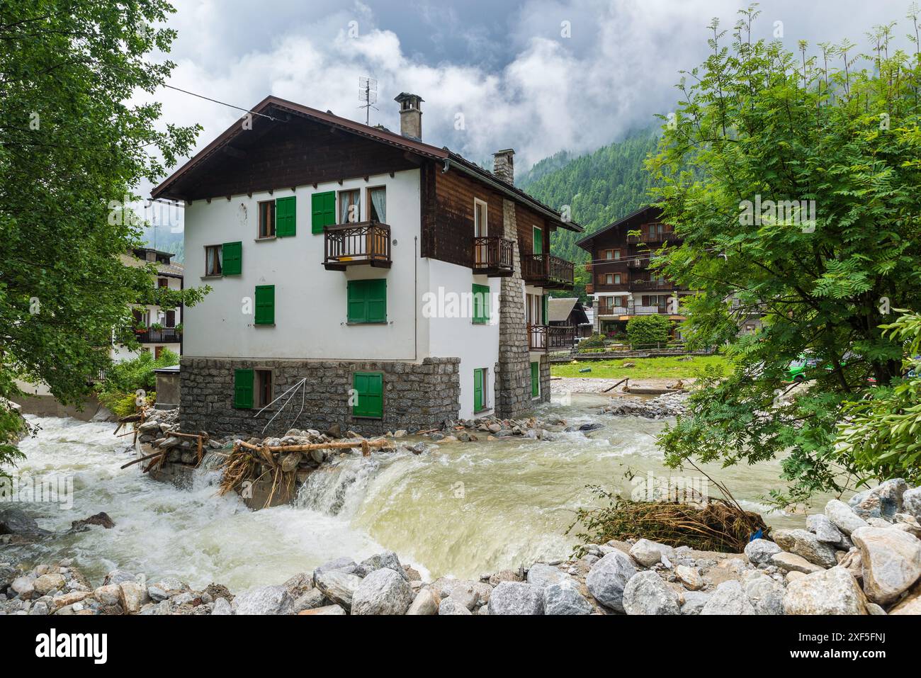 Torrent overflows and floods the streets and houses of a mountain ...