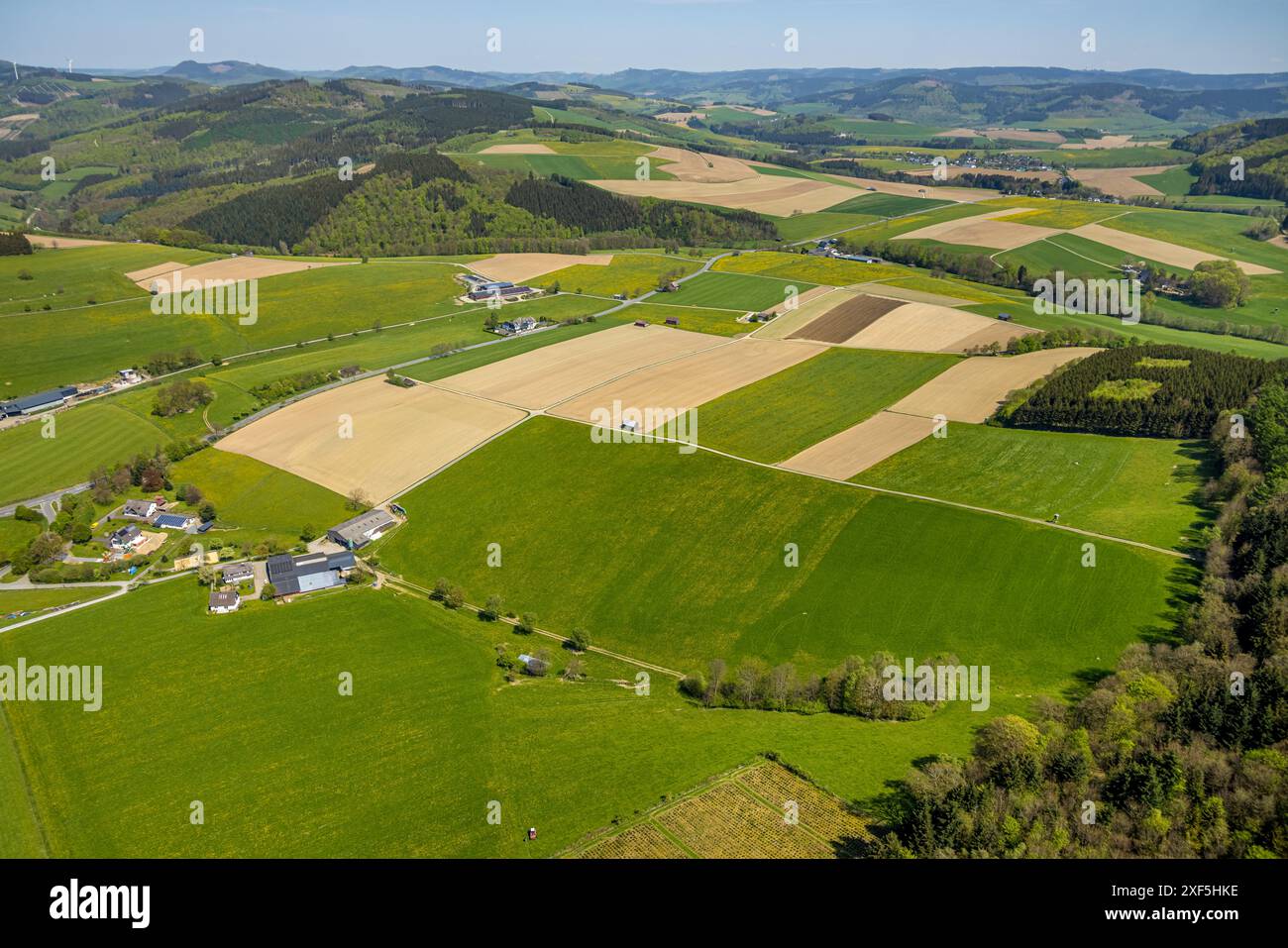 Aerial view, hilly landscape with forest, tiled structures meadows and ...