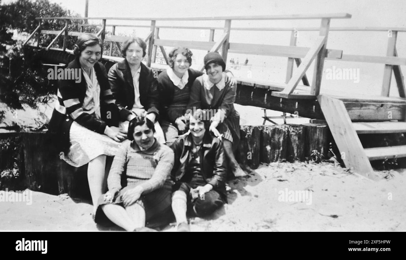 Fashion: A group of ladies beside a wooden footbridge, Lake Michigan ...