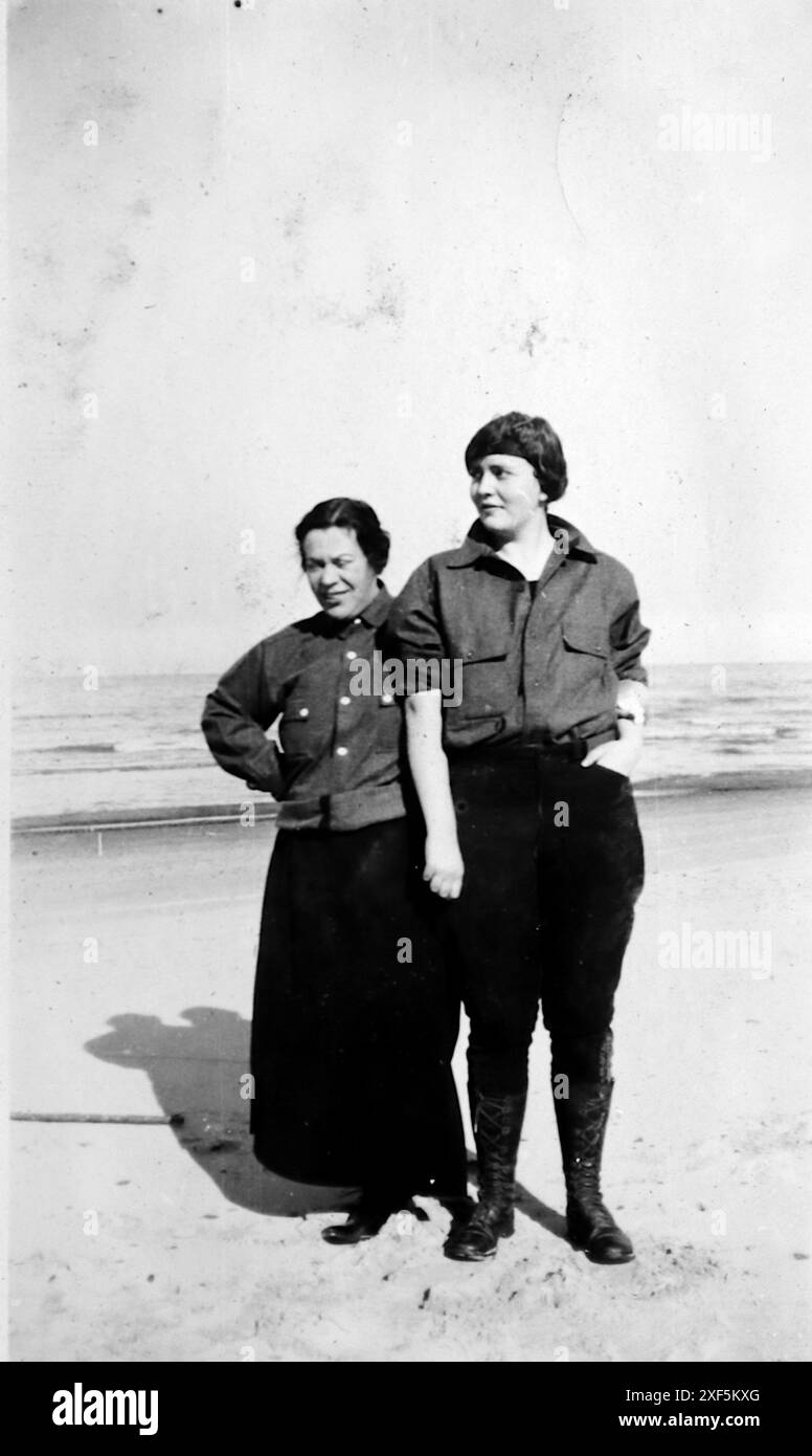 Fashion: Two ladies on a sandy beach, the sea behind them. Lake ...