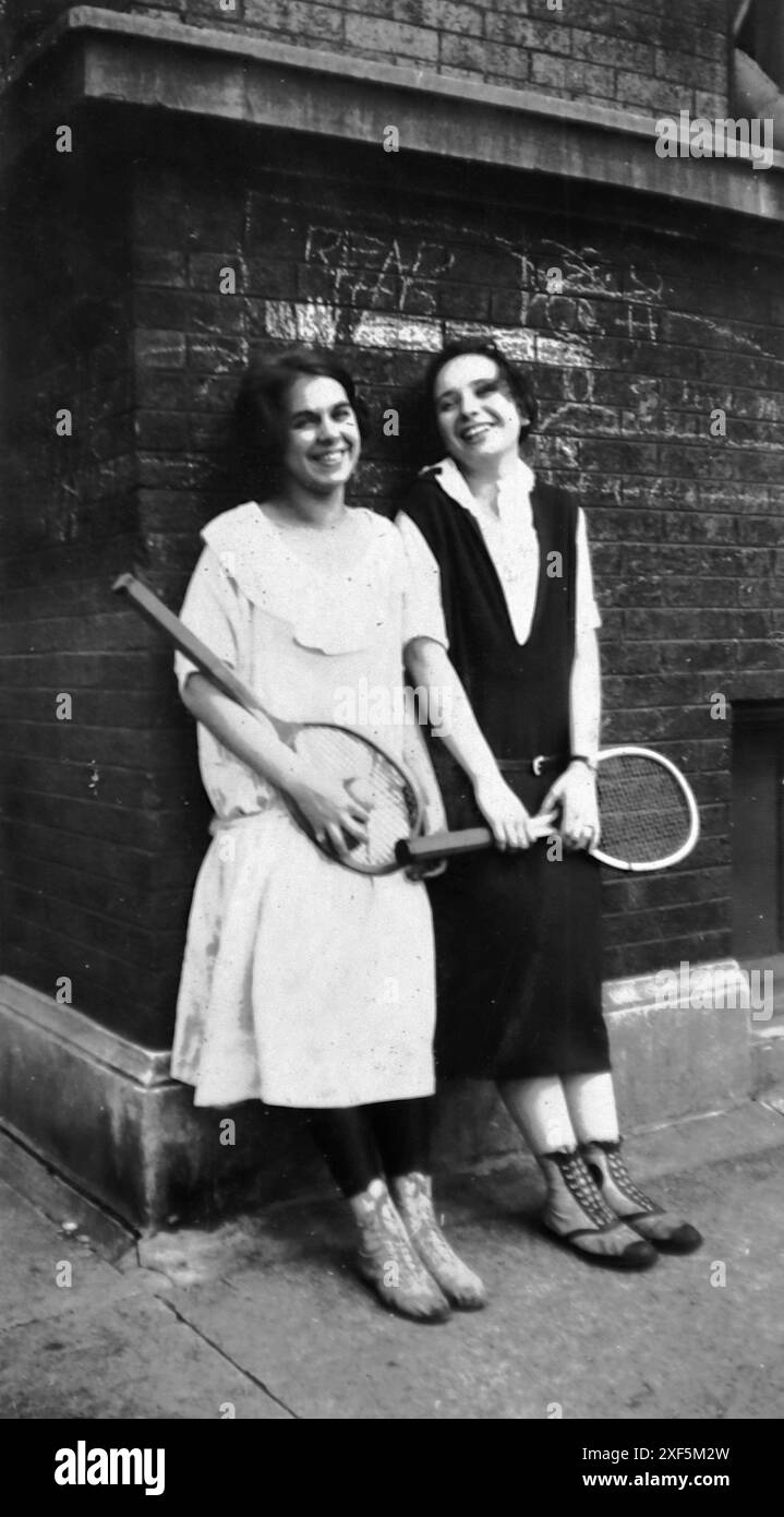 Fashion: Two young ladies with tennis rackets. USA. 1920. From a ...