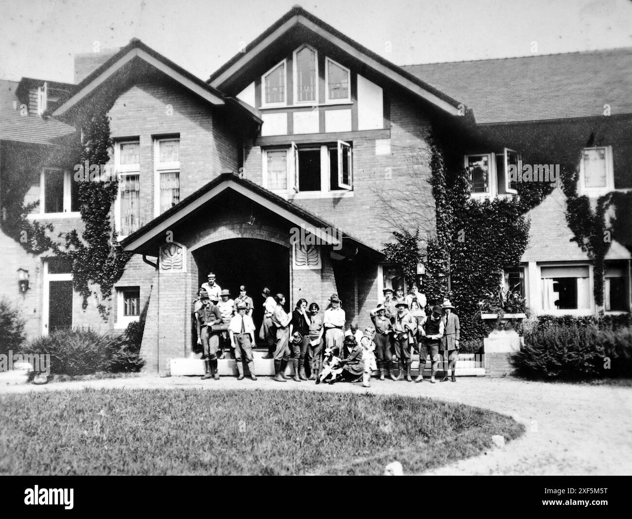 A group outside a large property, Chicago, USA. From a photograph album ...