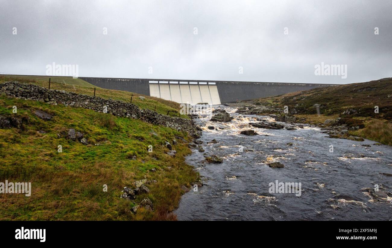 Cow Green Reservoir dam releasing flood water through the spillway into ...