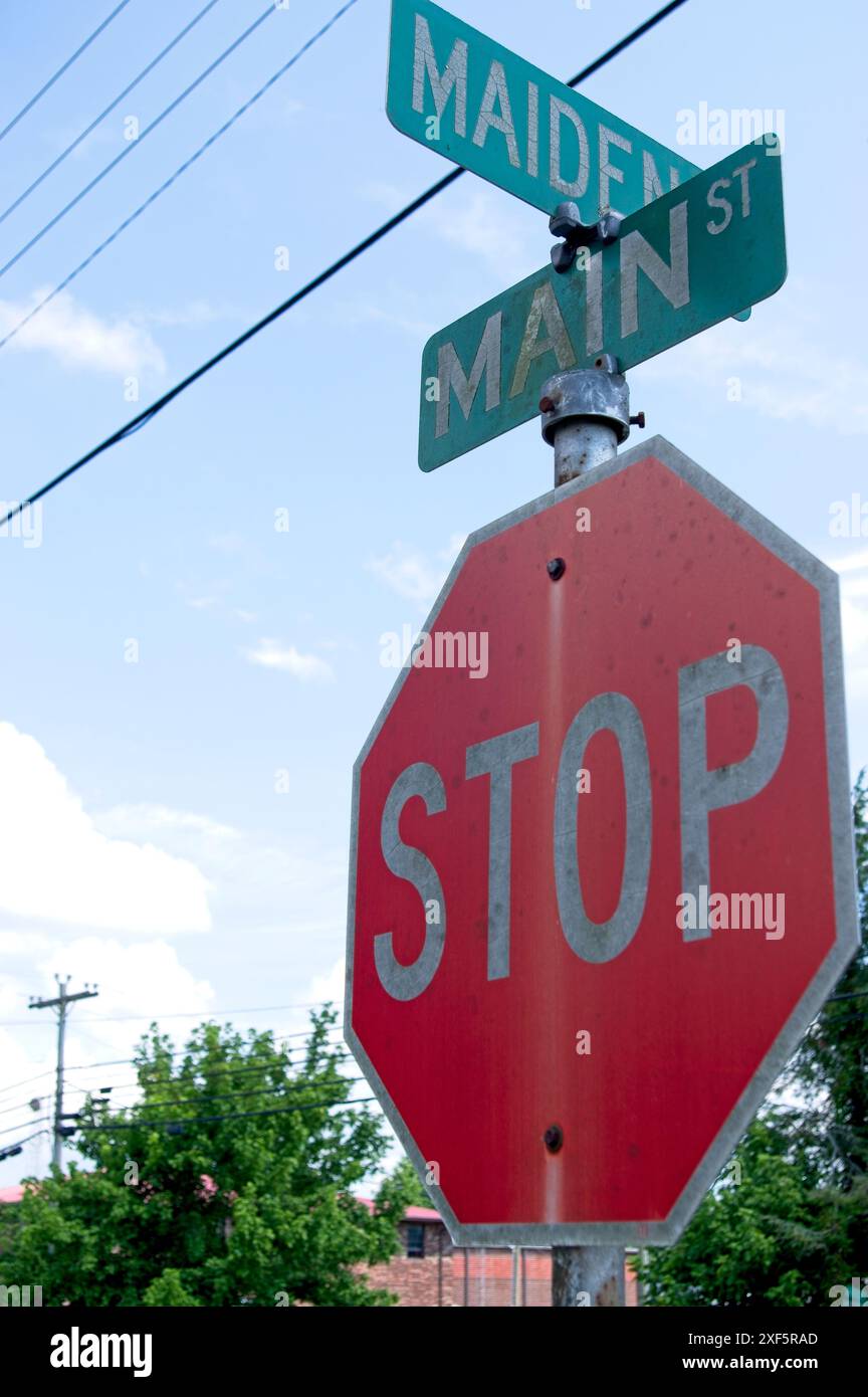 Street signs at an intersection above a faded stop sign Stock Photo - Alamy