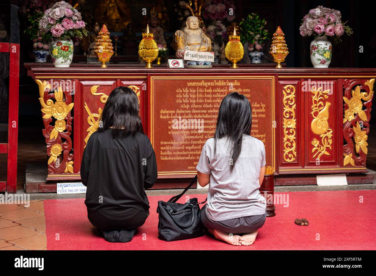 Bangkok, Thailand. 24th June, 2024. Women are seen praying inside the ...
