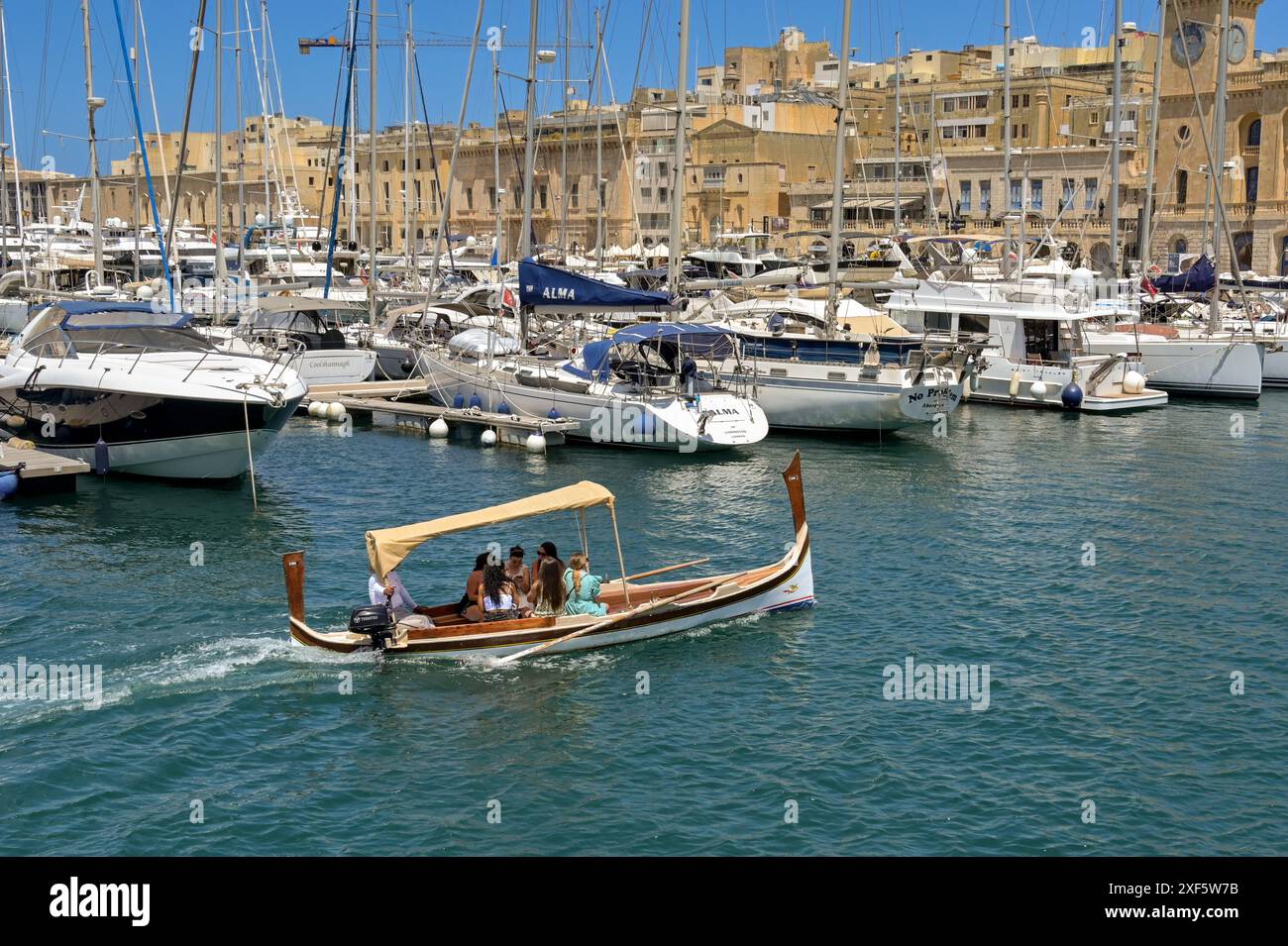 Valletta, Malta - 3 August 2023: Small water taxi taking passengers ...
