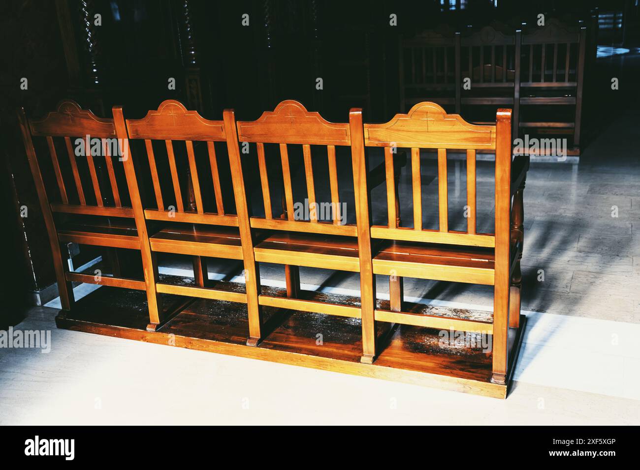 Wooden bench with four wooden chairs is empty. The bench is inside the ...