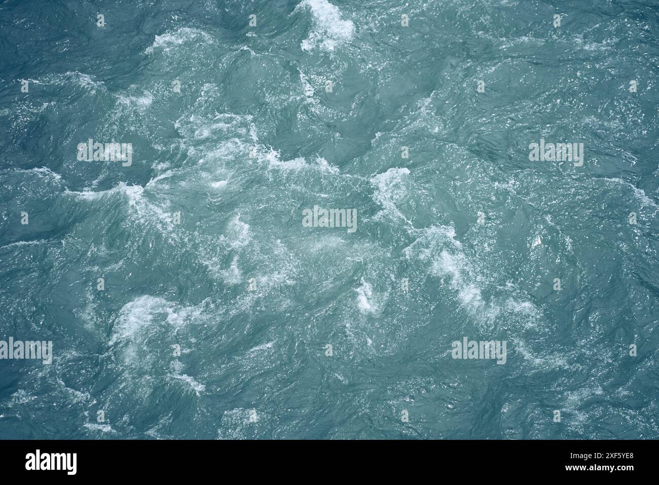 Ripples on the water from a wave. Background with a liquid texture ...