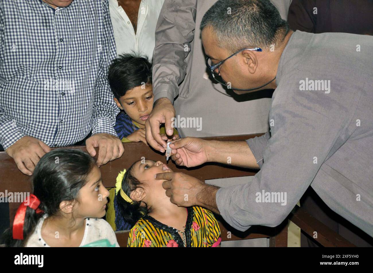 Health worker administrates polio-vaccine drops to a child during anti ...